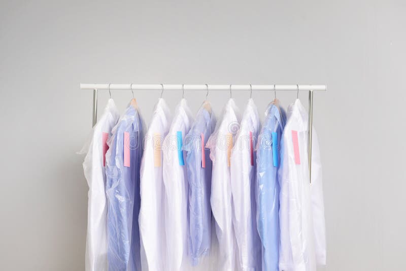 Rack with Clothes after Dry-cleaning on Light Background Stock Image ...