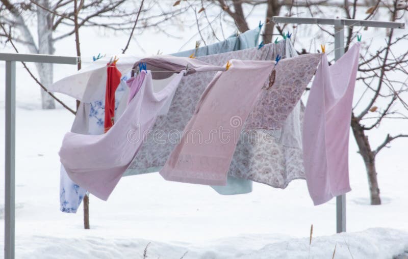 Snow on the clothesline stock photo. Image of frozen - 106596100