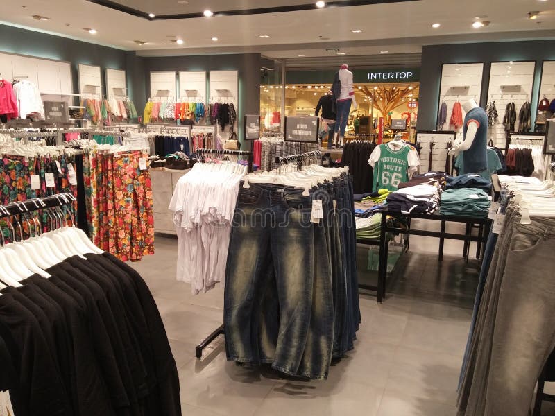 Clothes on shelves in shop editorial photo. Image of department - 50517251