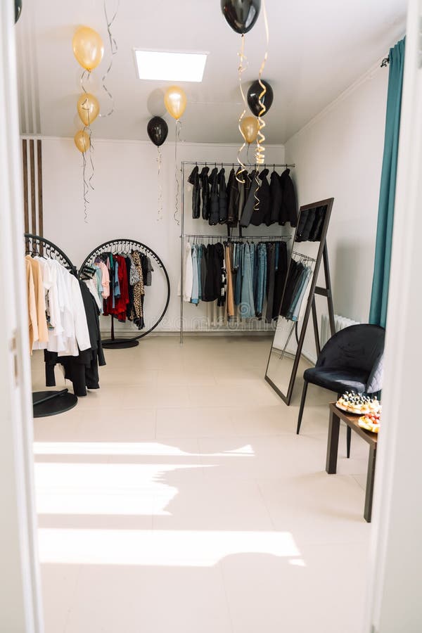 Clothes Store with Racks of Clothes and a Large Mirror Stock Photo ...