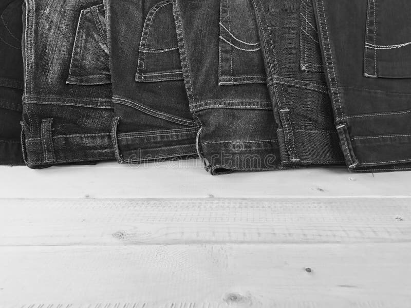 Dark jeans on wooden floor stock photo. Image of decoration - 97712218