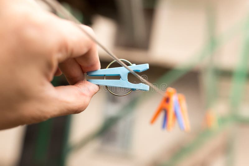 Clothespin in a Hand on a Clothesline Stock Photo - Image of white ...