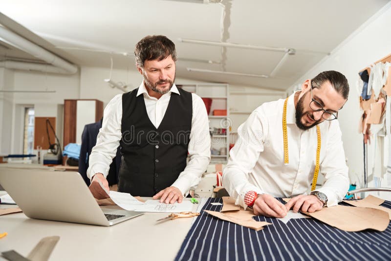 Clothier Working in Sewing Workshop Supervised by His Colleague Stock ...
