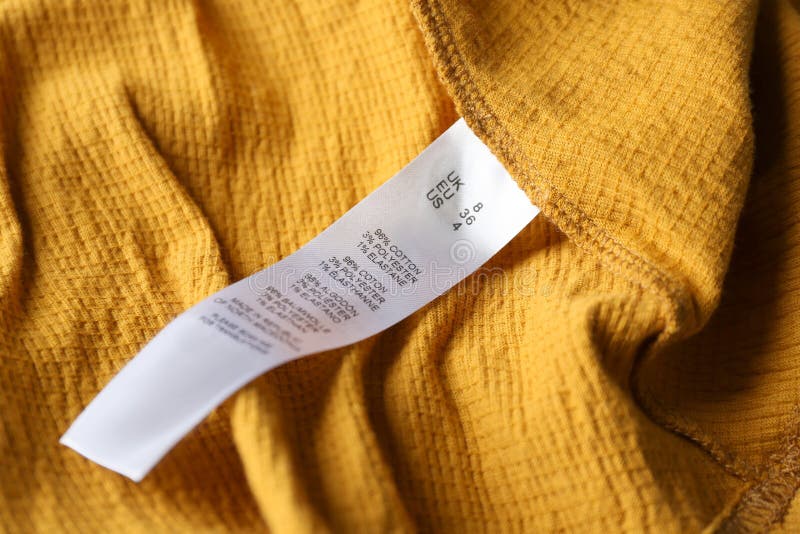 Clothing Label with Size and Content Information on Yellow Garment ...