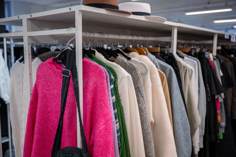 Clothing Rack with Jackets, Sweaters, and Accessories in Thrift Store ...