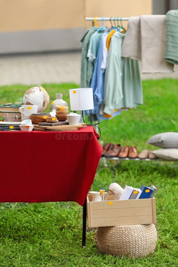 Clothing Rack and Table with Different Items on Garage Sale in Yard ...