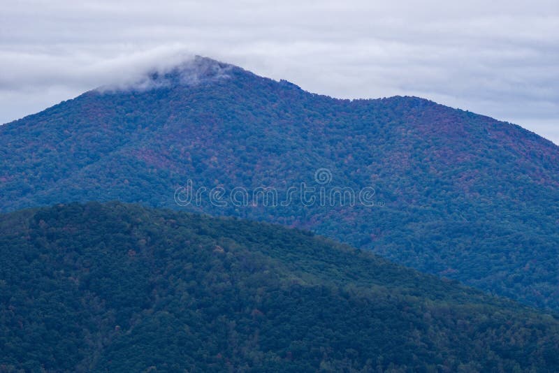 Cloud Covered Sharp Top Mountain Stock Image - Image of clouds ...