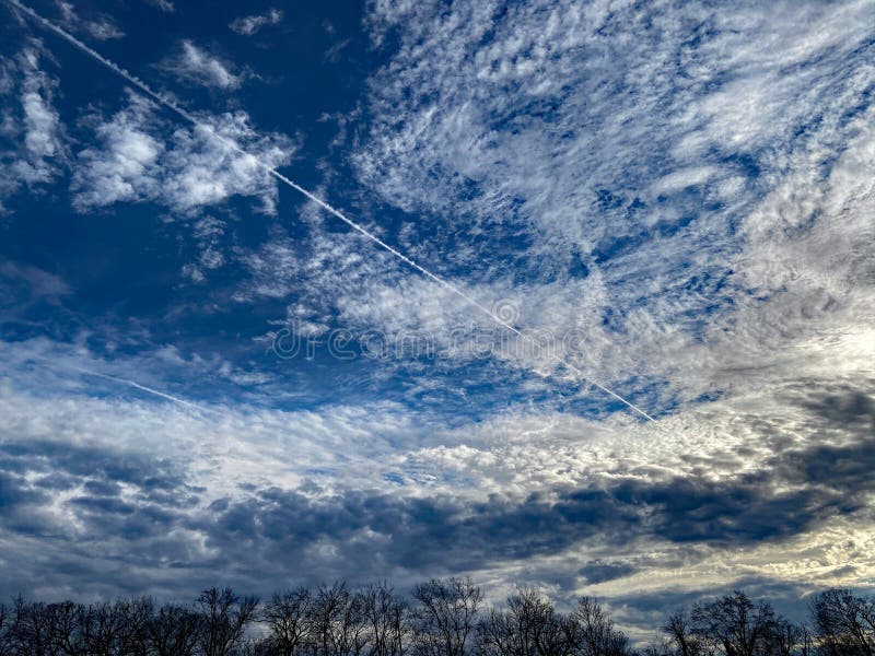 Cloud Formations and Jet Contrail Stock Photo - Image of grey, nature ...