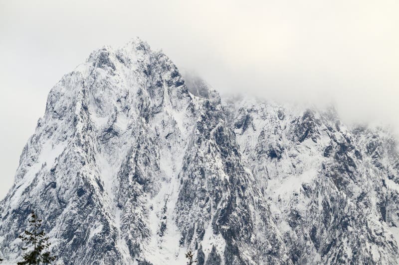 Cloud Hangs on the Rugged Snow Covered Peak of Mount Index in Winter ...