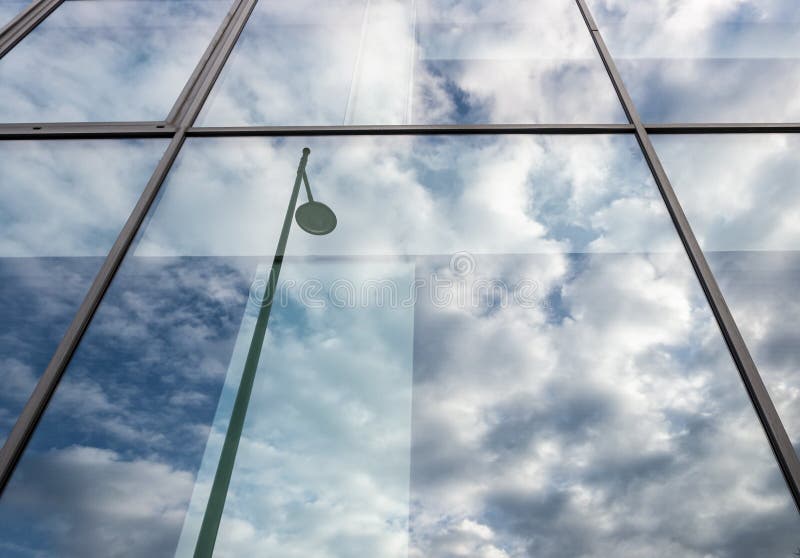 Cloud Reflections and Street Lamp in a Window of a Facade Stock Photo ...