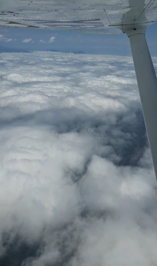 Cloud Surfing in an Airplane Stock Photo - Image of coast, cloudy ...