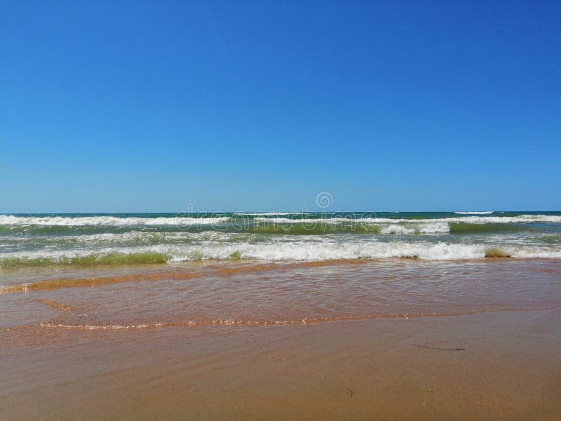 Cloudless Sky, Waves and Sandy Beach Stock Photo - Image of sand, sandy ...