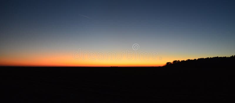 Cloudless Sunset on the Flat Field Stock Photo - Image of field, clouds ...