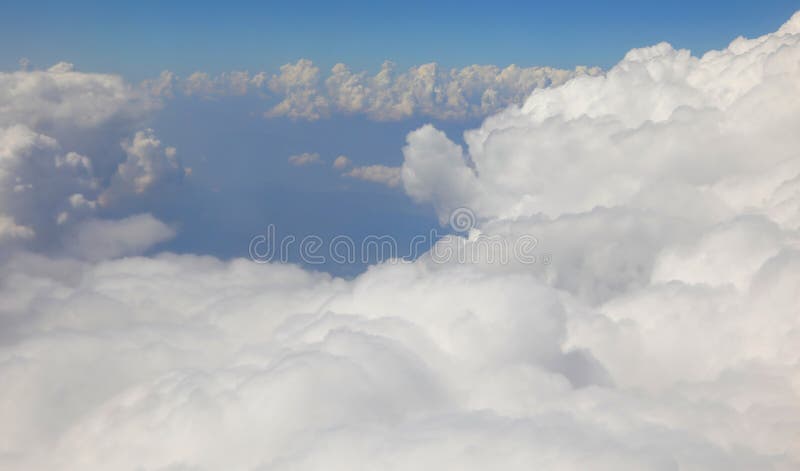 Clouds Below and the Blue Sky Seen from an Airplane during an ...