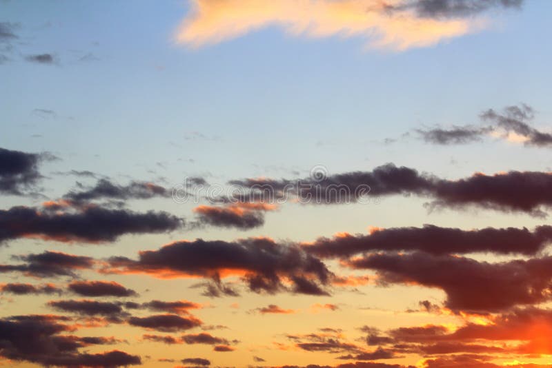 Clouds in the Blue Sky at Sunset or Dawn Backlit by the Sun. Place for ...