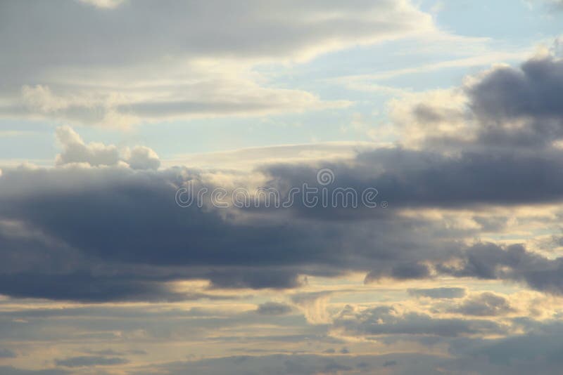 Clouds in the Blue Sky at Sunset or Dawn Backlit by the Sun. Place for ...
