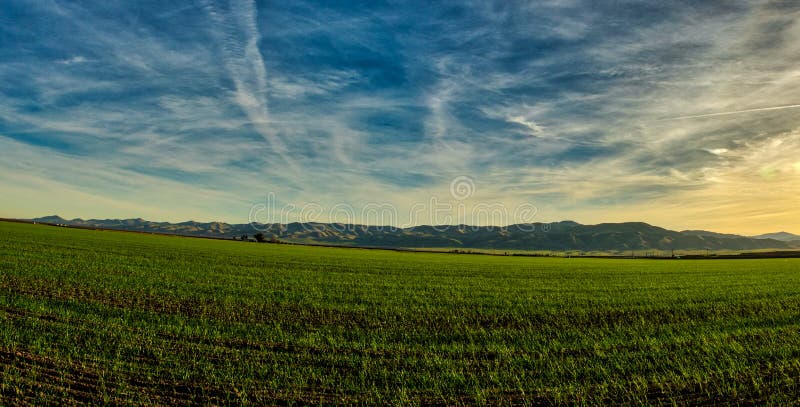 Clouds Field Sunset Green Distant Mountain Stock Photo - Image of dark ...