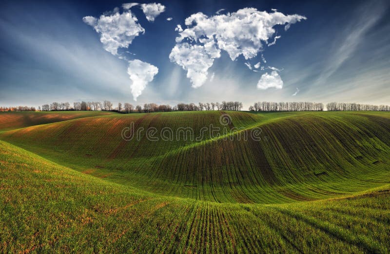 Clouds in the Form of a World Map Over a Green Field. Picturesque ...