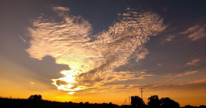 Clouds Forming a Heart Over the Sunset Stock Photo - Image of heartland ...