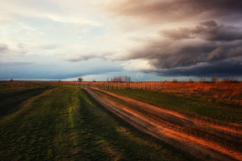 Clouds Gather Above a Serene, Open Landscape with a Long Path Stock ...