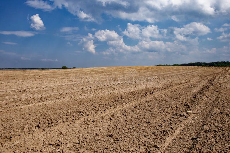 Clouds Hover Over a Large Expanse of Tilled Soil Stock Image - Image of ...
