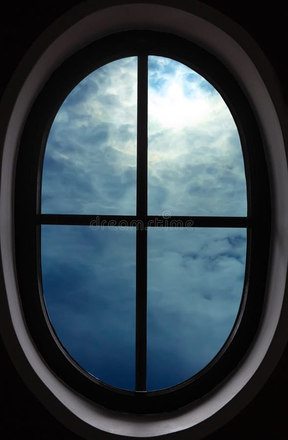 Clouds Illuminated by the Sun through the Oval Window Stock Photo ...