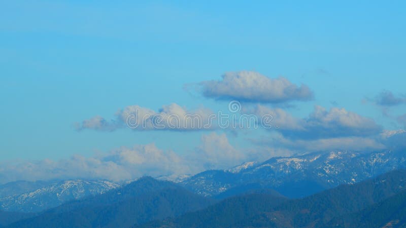 Clouds Opposite Direction with Mountain Range on Sunny Winter Day ...