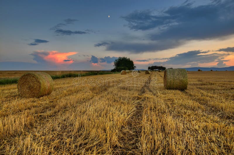 Clouds over field with hay stock photo. Image of farming - 43422392