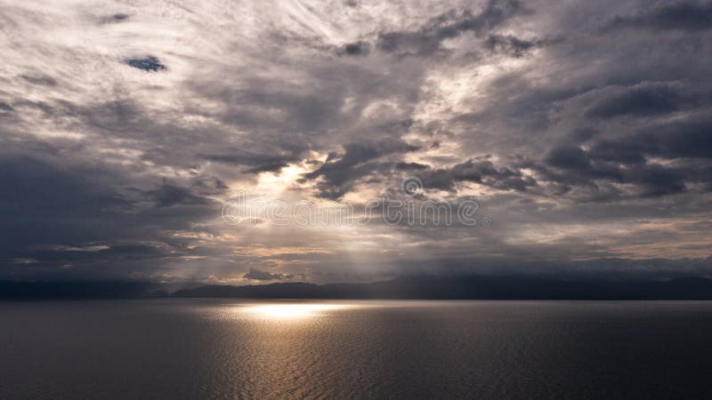 Clouds and Rays of Sun Above the Sea. Bright Light with Sun Rays and ...