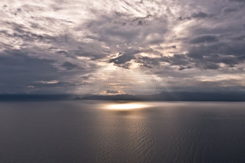 Clouds and Rays of Sun Above the Sea. Bright Light with Sun Rays and ...