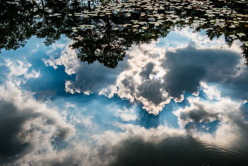 Sunlight And Clouds Reflect On The Water Stock Photo - Image of boat ...