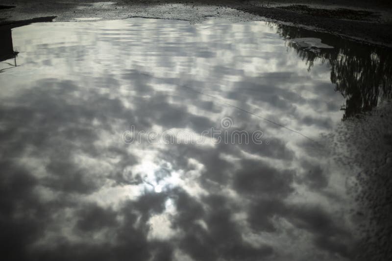 Clouds are Reflected in Puddle. Cloudy Weather Outside Stock Photo ...