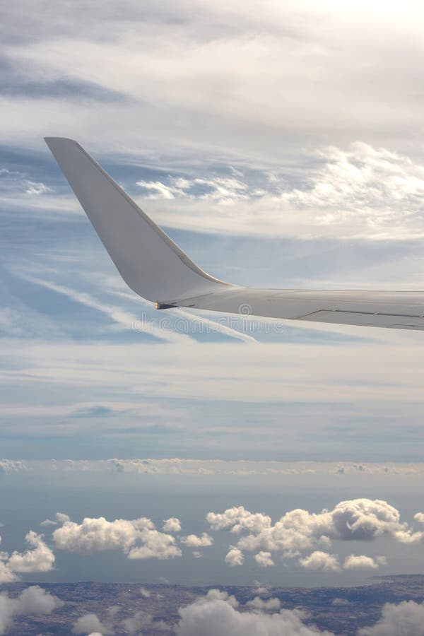 Clouds in the Sky Behind the Wing of an Airplane Stock Photo - Image of ...