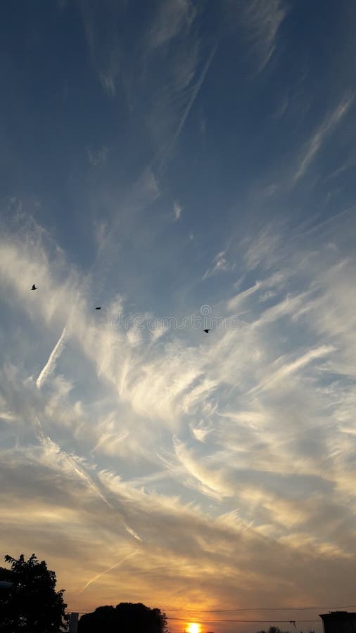 Sun Setting in Beautifully Patterned Clouds Having Traces of Airplane ...