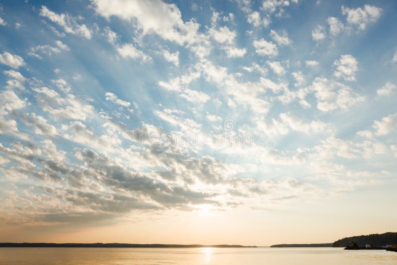 Clouds and Sun Rays Over Lake at Sunrise Stock Image - Image of ...