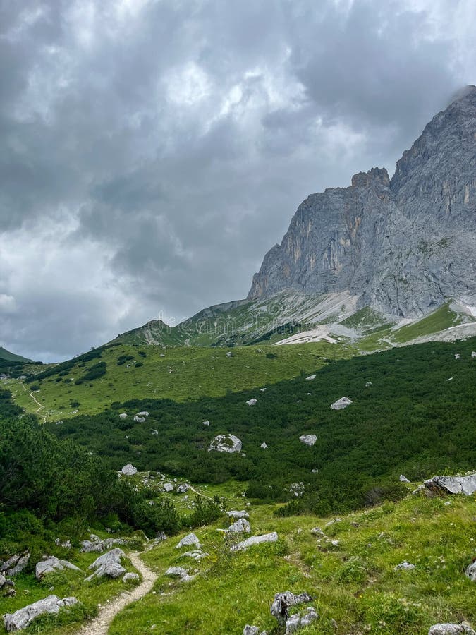 Cloudy Alpine Landscape stock image. Image of mountain - 386880871