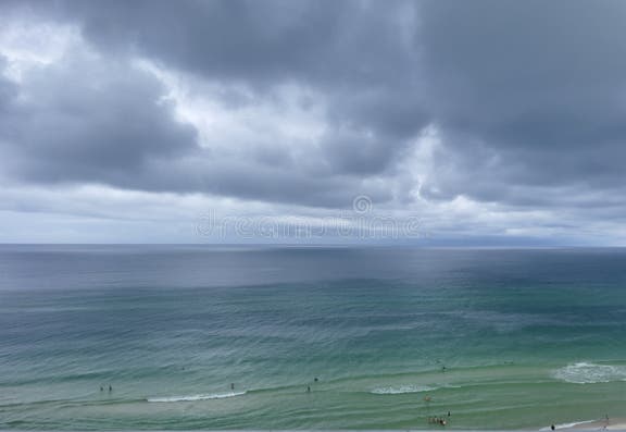 A Cloudy Beach Day with People Relaxing Stock Image - Image of relaxing ...