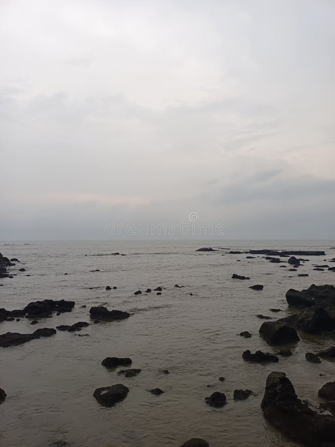 Cloudy beach in Goa India stock photo. Image of horizon - 255273162