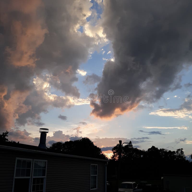 A Cloudy Colorful Summer Sunset in the Distance Stock Image - Image of ...