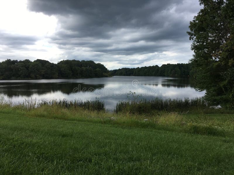 Cloudy Day at the Lake with Reflections Stock Image - Image of wetland ...