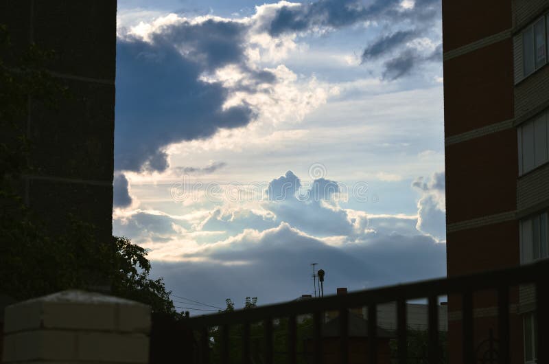 Cloudy Evening Landscape between Two Buildings in the Shade Stock Photo ...