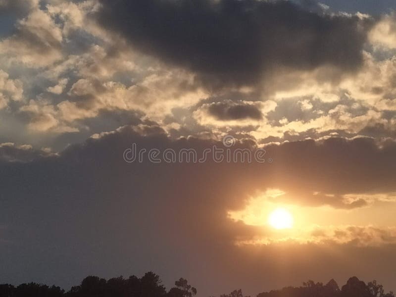 A Cloudy Evening with Sun stock image. Image of sunset - 192785995