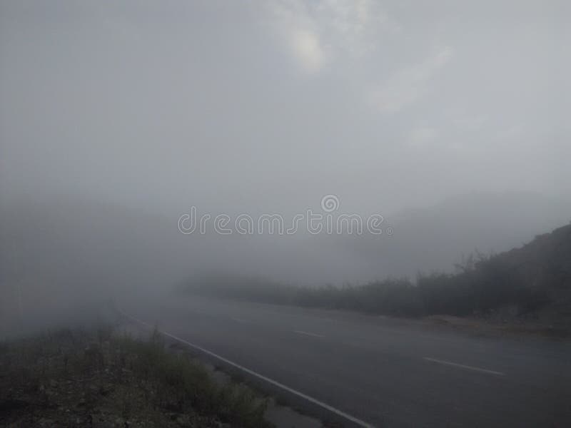 Cloudy. foggy. dark road stock image. Image of cold - 161369335