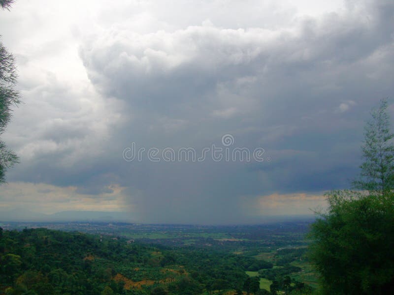 A Cloudy Raining in a Far View Stock Photo - Image of grassland, hill ...