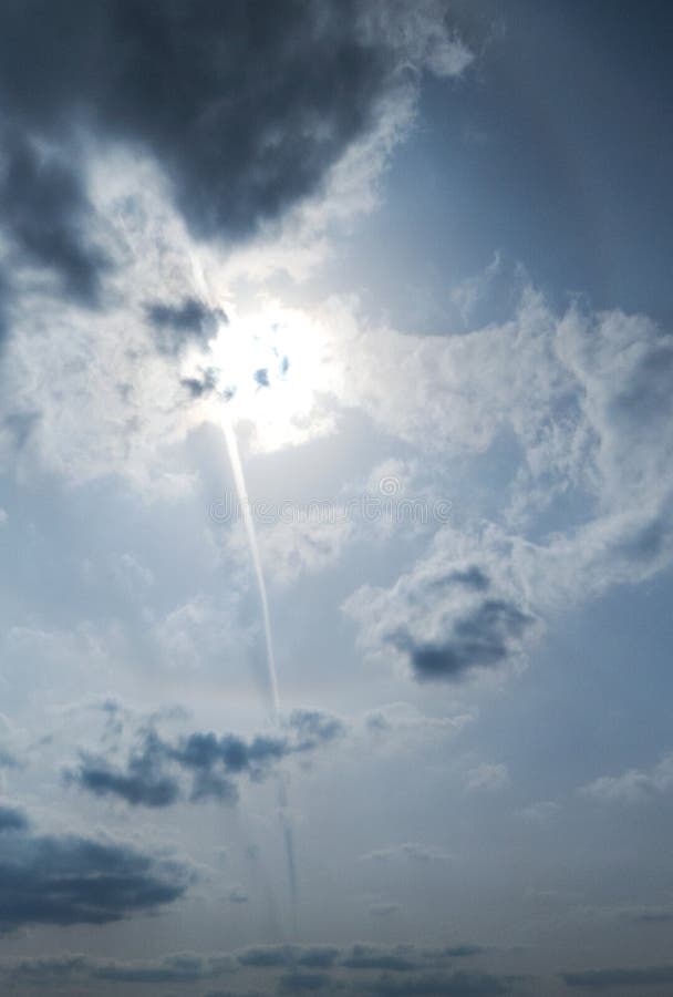 Cloudy Sky with a Contrail and a Low Light Halo Stock Image - Image of ...