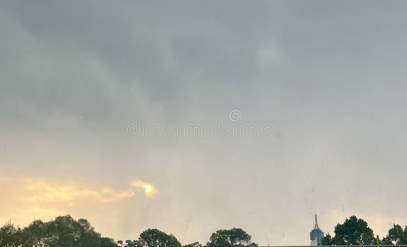 Cloudy Sky with Gray Clouds and Raindrops Falling during a Sunset Stock ...