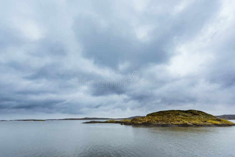 Cloudy sky with an island stock photo. Image of view - 87751214
