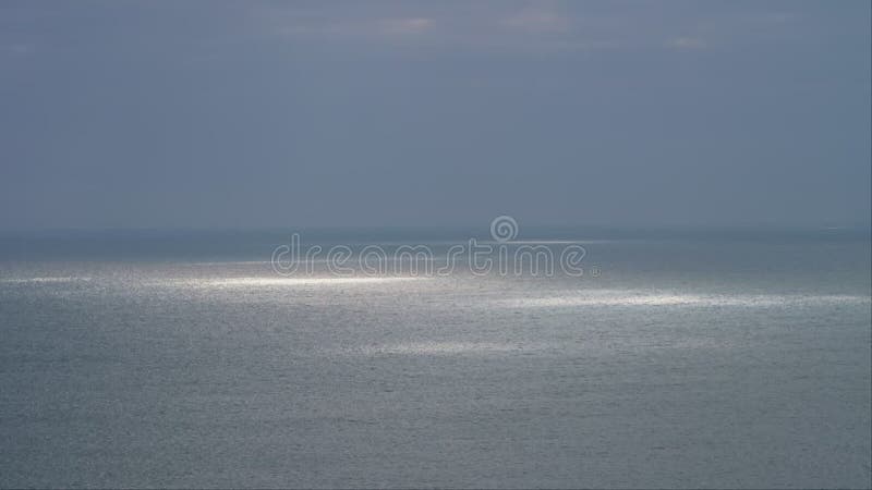Cloudy Sky almost Merging with the Sea on the Horizon through Which the ...
