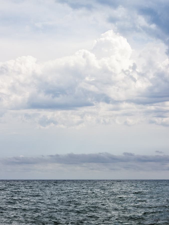 Cloudy Sky Over the Horizon in the Ocean. Vertical Seascape Background ...