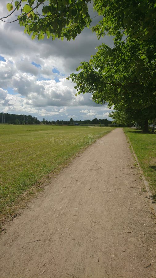 Cloudy sky over path stock photo. Image of diatomite - 93698300